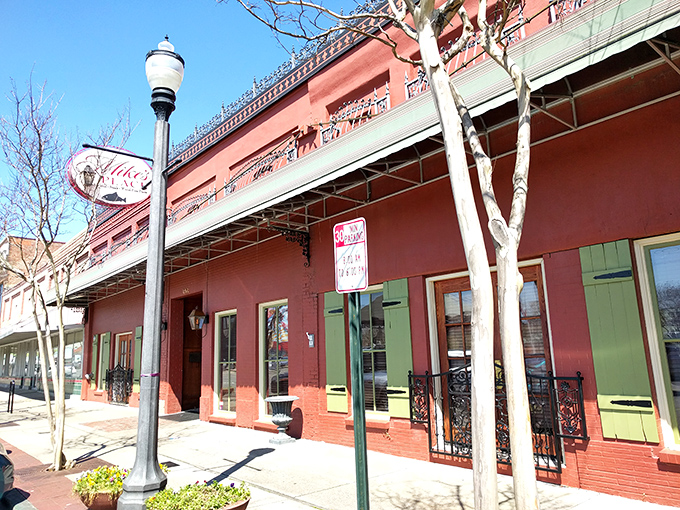 The brick-red exterior of Mike's Place stands as Conway's culinary beacon, its green shutters and vintage sign promising delicious adventures within.