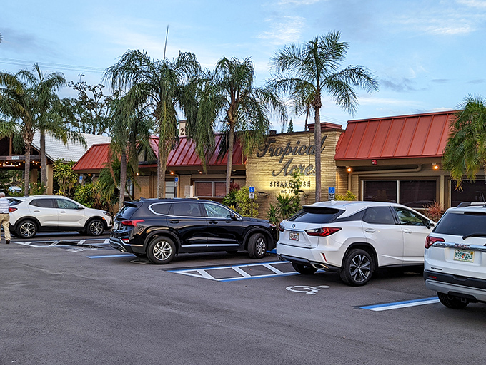 The iconic yellow brick facade of Tropical Acres Steakhouse stands as a time capsule of old Florida dining, palm trees standing guard like culinary sentinels.