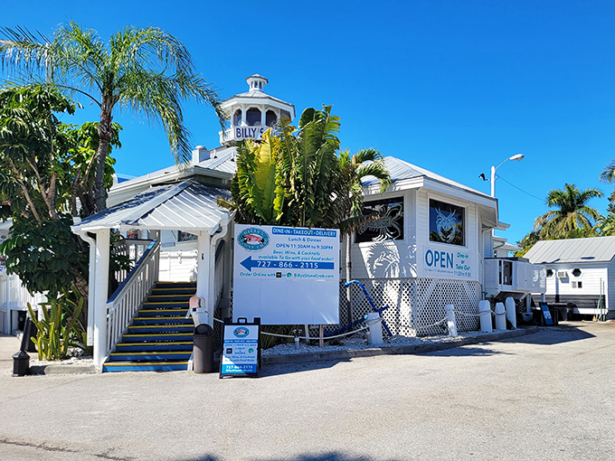 The iconic white lighthouse-topped entrance to Billy's Stone Crab beckons seafood lovers up those blue steps like a siren call to paradise.