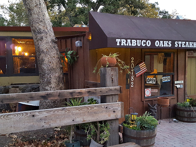 This rustic steakhouse exterior whispers "authentic" louder than a dinner bell at suppertime.