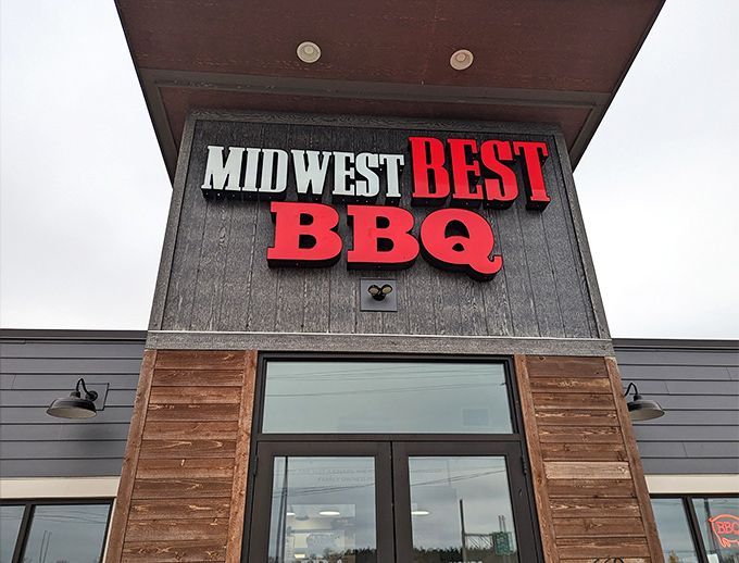 The bold red lettering against dark wood siding isn't just signage&mdash;it's a beacon for barbecue pilgrims seeking smoky salvation in Loveland.