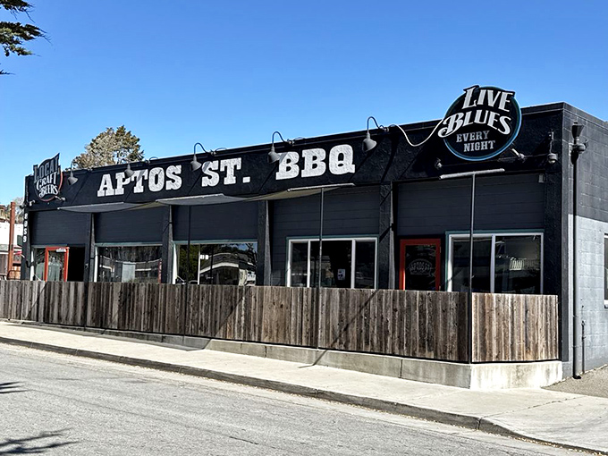 The blue exterior of Aptos St. BBQ stands like a beacon of hope for hungry travelers, promising smoky delights and blues music within.