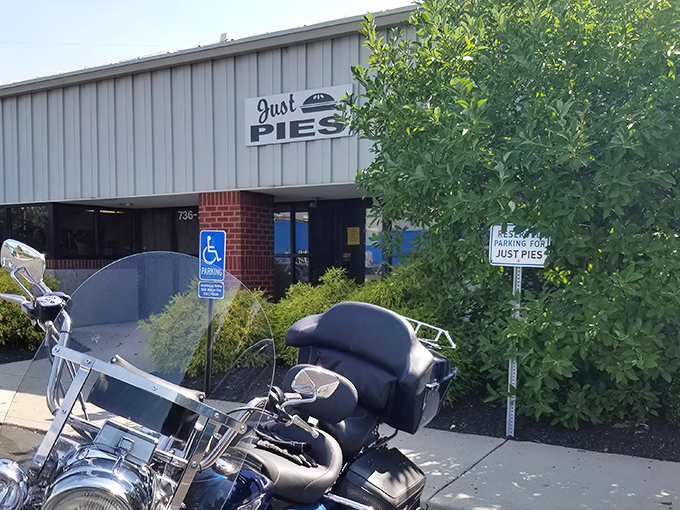 The unassuming exterior of Just Pies proves once again that culinary greatness rarely comes with flashy packaging.