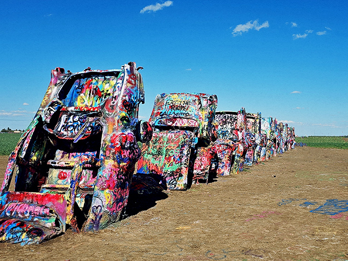 Ten Cadillacs nose-diving into the Texas dirt like synchronized swimmers who forgot the "swimming" part. American automotive history meets desert art installation.