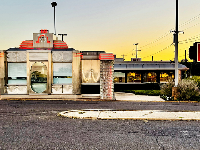 Gleaming in the sunset glow, The Dining Car's classic stainless steel exterior promises a time-traveling culinary adventure that begins before you even step inside.