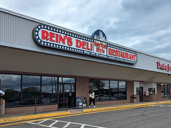 The iconic Rein's Deli sign glows like a beacon for hungry travelers on I-84, promising authentic New York deli magic in the heart of Connecticut.