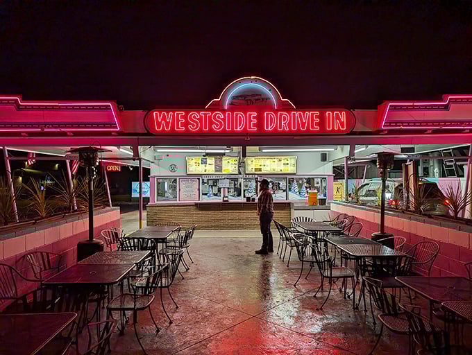 The pink and turquoise facade of Westside Drive In stands like a time capsule of Americana, beckoning hungry travelers with promises of comfort food perfection.