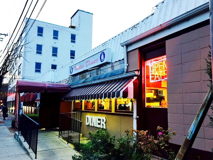 The iconic silver exterior of Tastee Diner stands as a time capsule amid Bethesda's modern landscape, like a chrome-plated guardian of comfort food traditions.