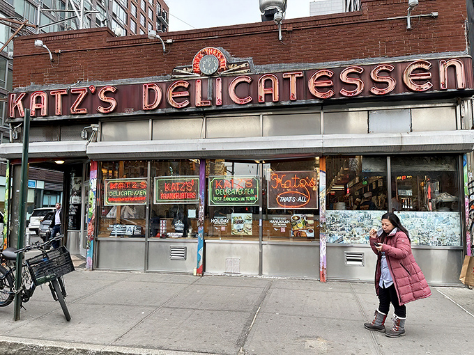 The iconic neon sign of Katz's Delicatessen glows like a beacon for hungry souls on Houston Street, a timeless landmark in a constantly changing city.