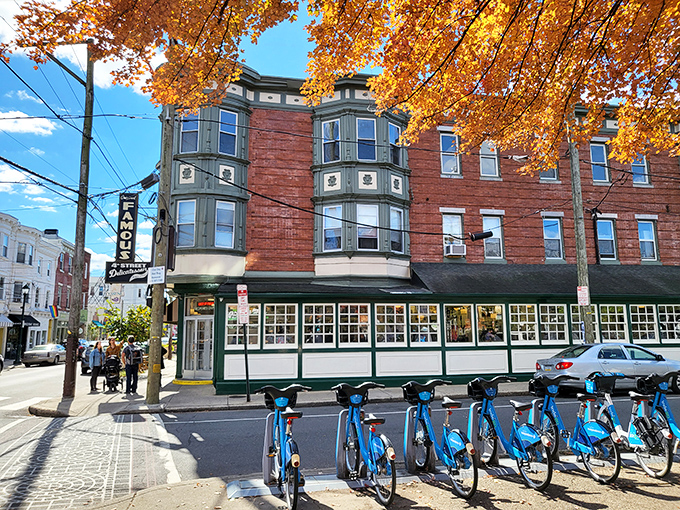 The iconic brick corner building housing Famous 4th Street Delicatessen stands like a time capsule in Philadelphia's Queen Village. Green-trimmed windows hint at the culinary treasures within.