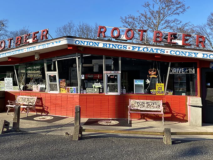 The iconic red exterior of The Root Beer Stand glows like a beacon of nostalgia, promising frosty mugs and comfort food that transcends time.