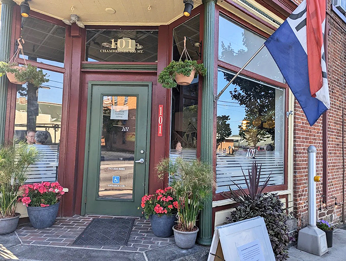 The welcoming entrance to Kitchen 101 feels like a secret doorway to sandwich paradise, complete with charming flower pots and historic brick fa&ccedil;ade.