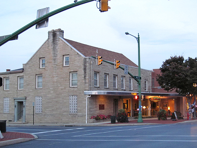 Palermo's Pizza stands as a colorful sentinel on Hummelstown's Main Street, where red umbrellas beckon like culinary lighthouses guiding hungry travelers home.