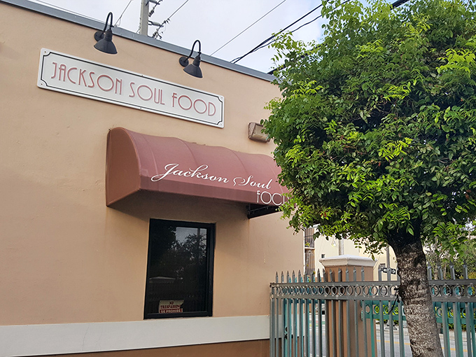 The unassuming peach-colored exterior with its burgundy awning is Miami's soul food beacon &ndash; no flash, just pure culinary promise waiting inside.