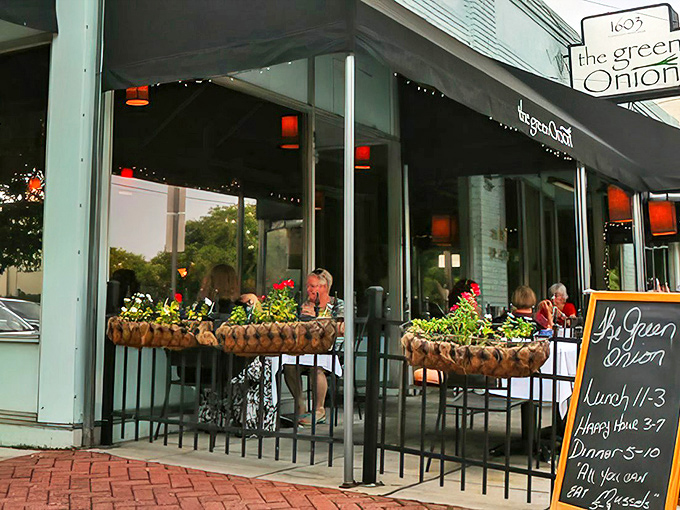 The sidewalk patio at The Green Onion beckons like an old friend, with flower boxes that could make a botanist blush with envy.