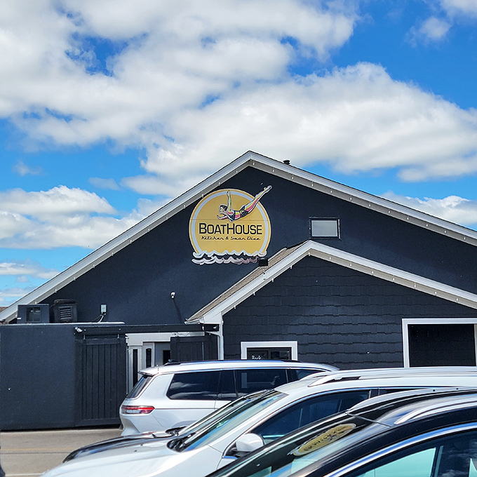 The navy blue exterior of Boathouse Kitchen & Swan Dive stands proud against Indiana's sky like a nautical oasis in a sea of cornfields.