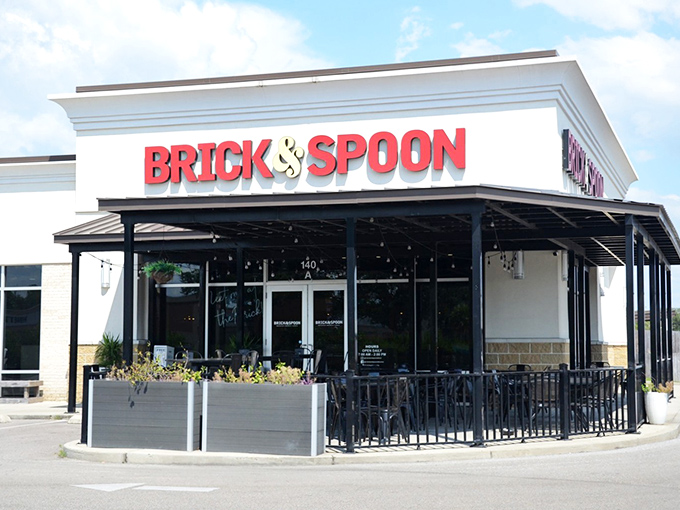 The red signage of Brick & Spoon gleams like a beacon for breakfast lovers. The patio beckons with promise of morning feasts and mimosa-fueled conversations.