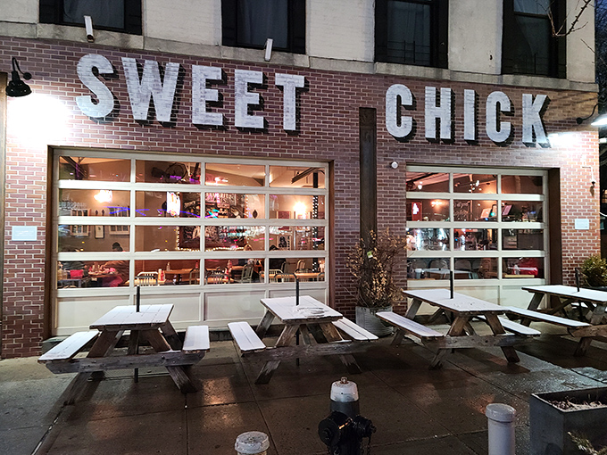 The unmistakable pink brick exterior of Sweet Chick beckons hungry passersby with its warm glow and picnic tables that practically whisper, "Pull up a seat, friend."