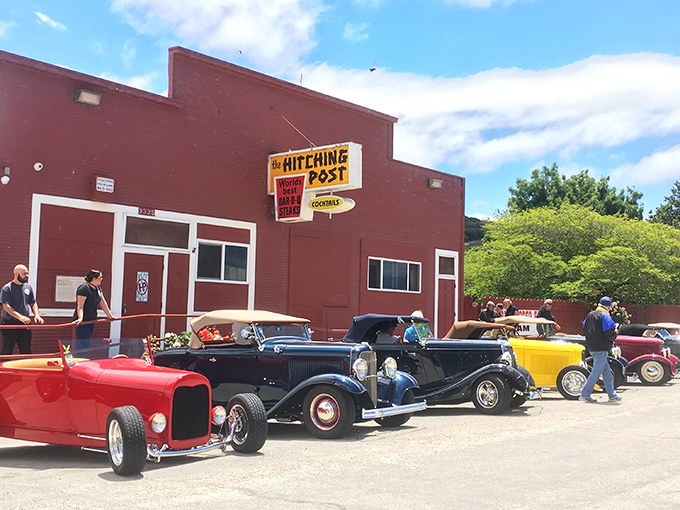 The red exterior of The Hitching Post stands like a culinary lighthouse in Casmalia, beckoning hungry travelers with promises of smoky perfection.
