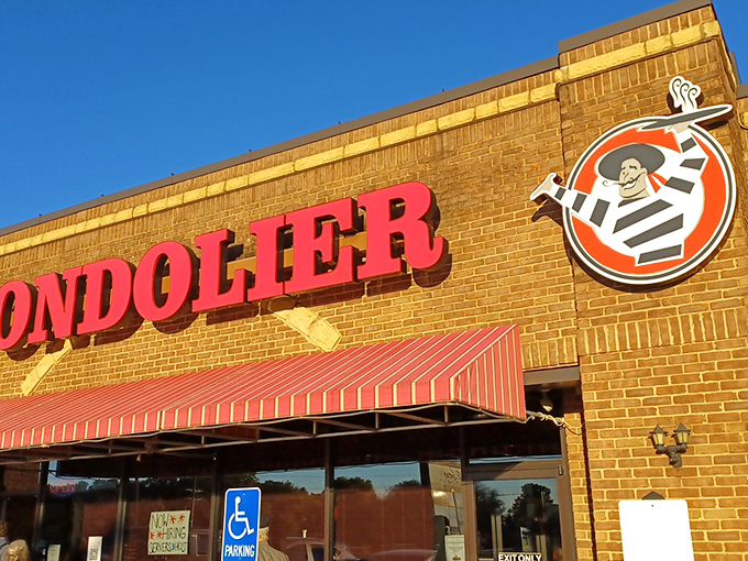 The bold red Gondolier sign beckons like a lighthouse for pasta pilgrims, promising Italian comfort under those distinctive striped awnings.