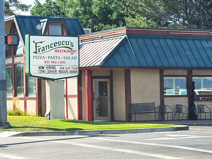 Francesco's modest exterior hides culinary treasures within, like finding a Lamborghini parked behind a garden shed. The blue awning signals Italian delights await.