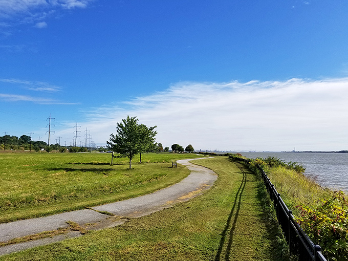 The winding riverside path beckons like nature's welcome mat, inviting you to leave your worries at the entrance sign and just breathe.