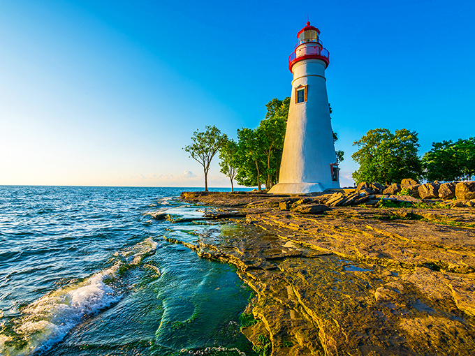 Standing tall since 1821, this gleaming white sentinel with its cherry-red cap has guided sailors through Lake Erie's treacherous waters for two centuries.
