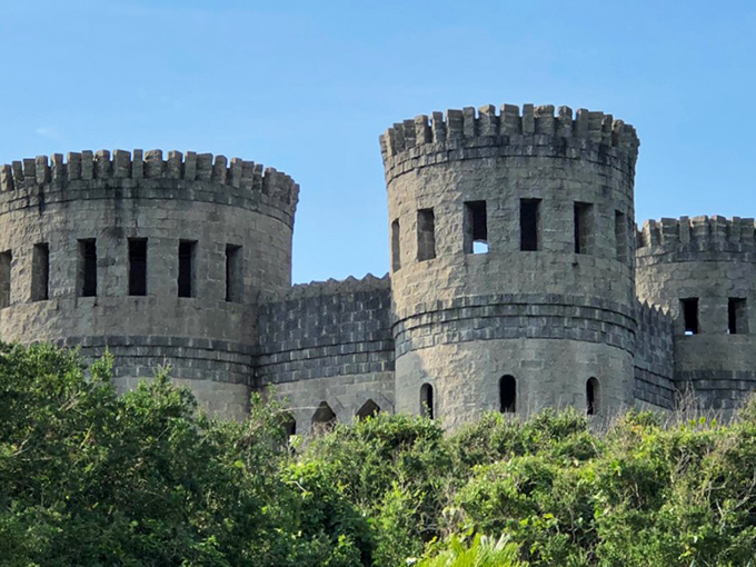 Castle Otttis emerges from Florida's coastal vegetation like a medieval mirage, its coquina stone towers standing defiantly against the bright blue sky.