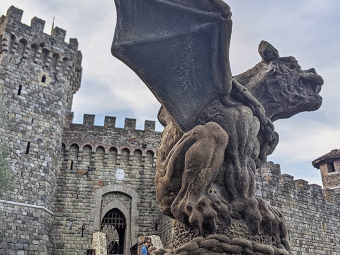 The castle entrance guarded by a stone gargoyle that looks like it might come alive after hours. Medieval fantasy meets California sunshine in this imposing entryway.