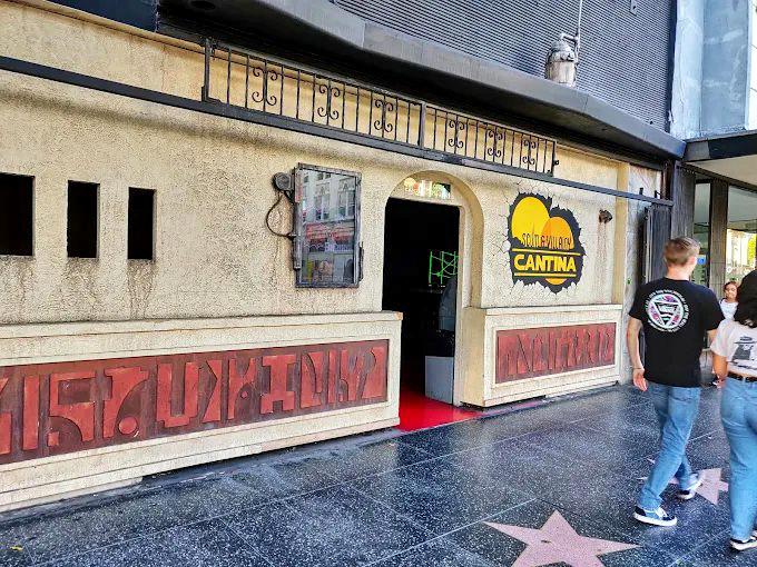 The unassuming exterior of Scum and Villainy Cantina beckons from Hollywood Boulevard, its cracked-wall logo promising adventure before you even step inside.