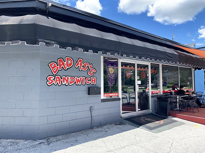 The unassuming gray exterior hides sandwich greatness within. Like a culinary speakeasy, Bad As's bold red sign is your invitation to flavor paradise.