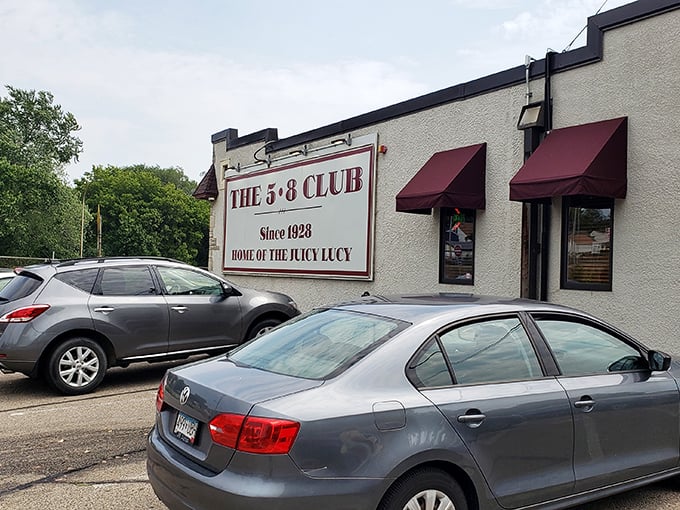 The unassuming exterior of 5-8 Club hides culinary greatness behind those burgundy awnings, proving that in Minnesota, legendary burgers don't need fancy facades.