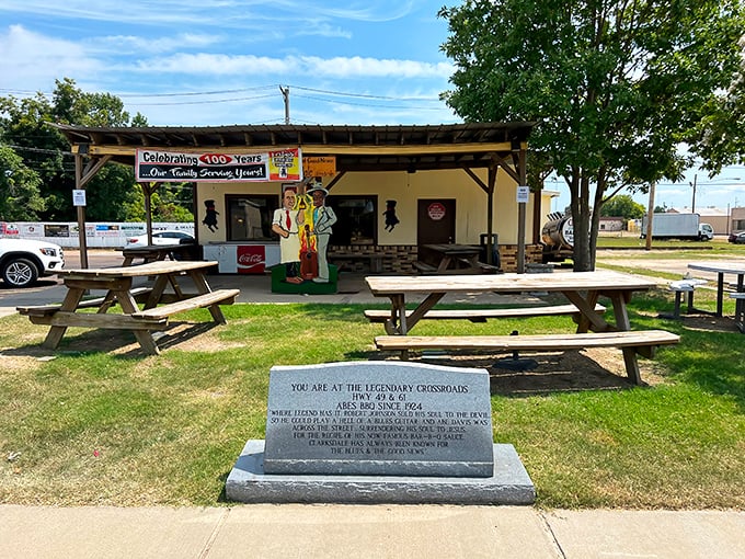 The humble yellow exterior of Abe's Bar-B-Q stands like a beacon at Clarksdale's famous crossroads, wooden picnic tables inviting weary travelers to sit a spell.
