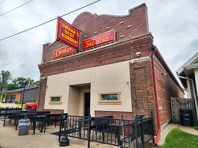 The neon doesn't lie! Dinker's iconic sign promises Omaha's best burger, and that brick exterior has witnessed decades of satisfied customers.