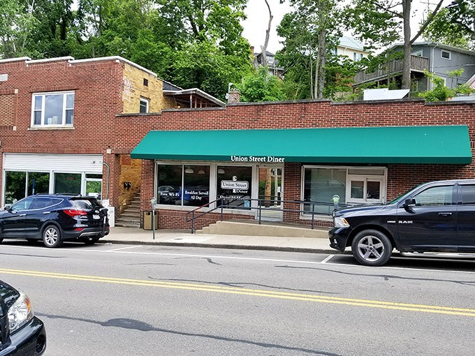 The unassuming brick exterior with its signature green awning promises comfort food magic within. Athens' hidden breakfast gem awaits.