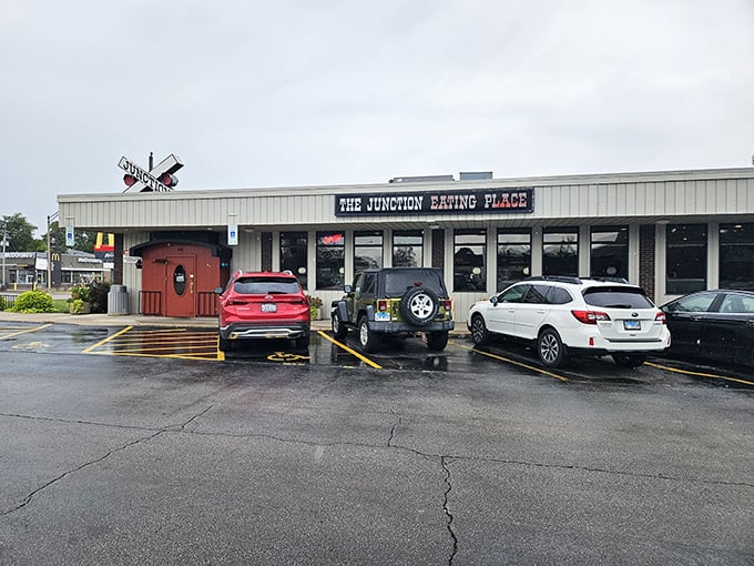 The railroad crossing sign perched atop this unassuming DeKalb diner isn't just decoration&mdash;it's a promise of the journey your taste buds are about to take.