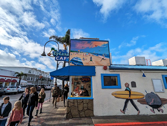 The iconic blue-and-white exterior of Splash Caf&eacute; stands like a beacon for chowder pilgrims, complete with that charming surfboard signaling delicious waves ahead.