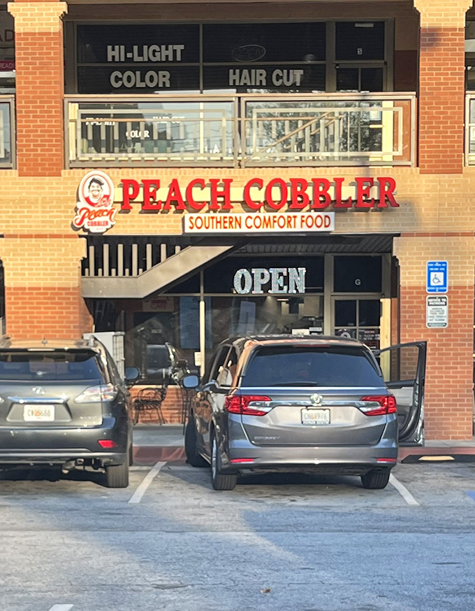 The bright red "PEACH COBBLER" sign beckons like a siren song to hungry travelers. Resistance is futile when Southern comfort food calls your name.