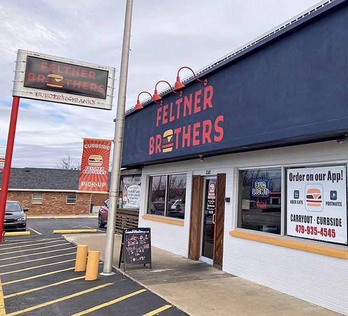 The red and black signage stands like a beacon of burger hope against the Arkansas sky. Simple, straightforward, and promising delicious things inside.