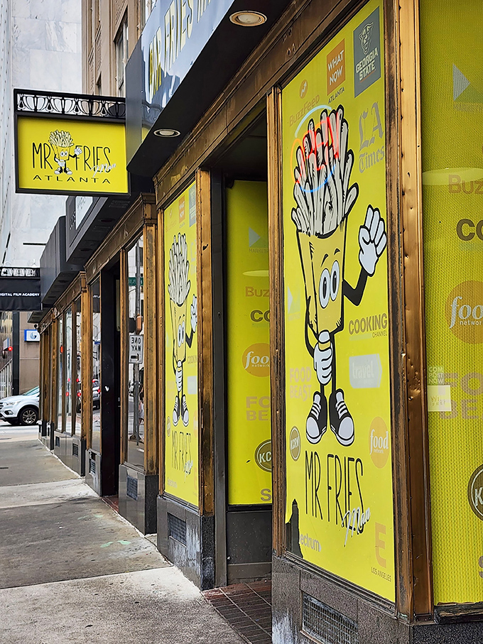 The bright yellow storefront stands out like a beacon of potato promise, with the cartoon fry mascot practically waving you inside.