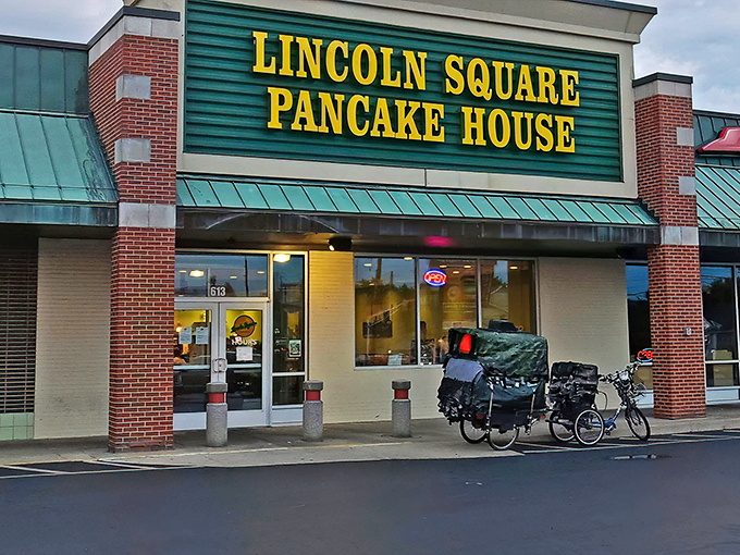 The iconic green and yellow sign beckons hungry travelers like a breakfast lighthouse guiding morning-starved sailors to pancake paradise.