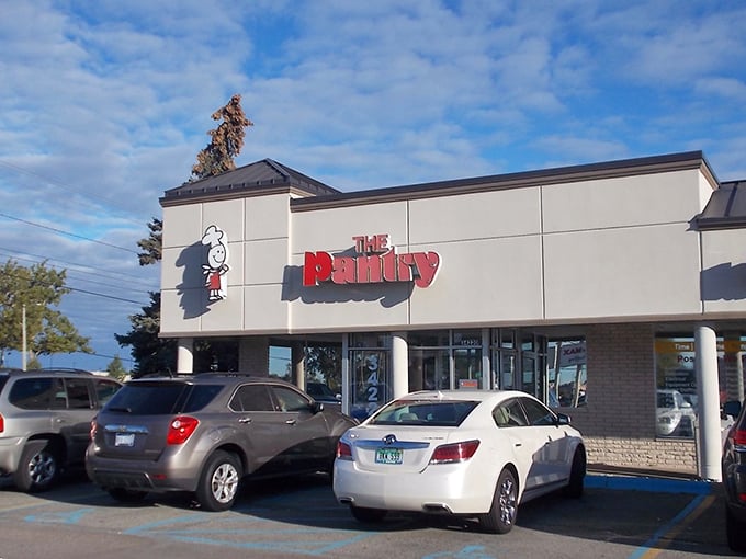 The unassuming exterior of The Pantry Restaurant, where breakfast dreams come true and parking spots are worth their weight in maple syrup.
