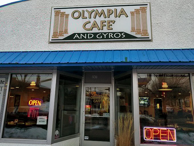 The blue-trimmed facade of Olympia Cafe beckons like a Mediterranean mirage in suburban Osseo, promising Greek delights and all-day breakfast adventures.