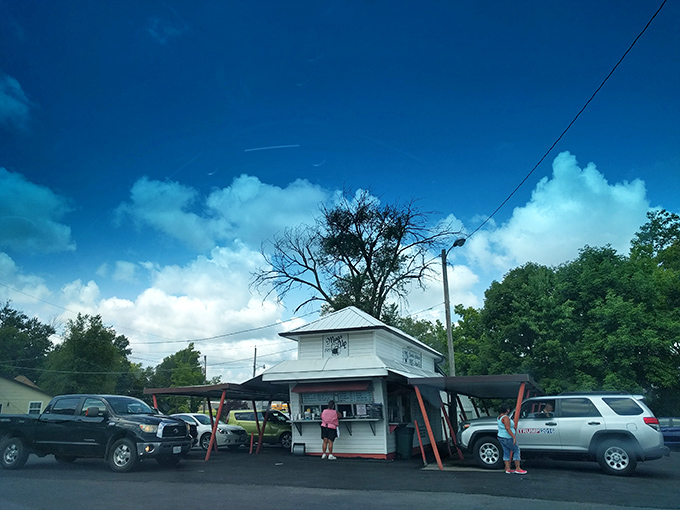 The humble white building with its distinctive orange-red supports stands like a time capsule of American drive-in culture. Simple perfection awaits.
