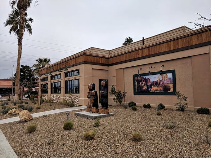 The rustic stone-and-timber facade of Black Bear Diner stands like a mountain lodge mirage in the Nevada desert, promising comfort food salvation to weary travelers.