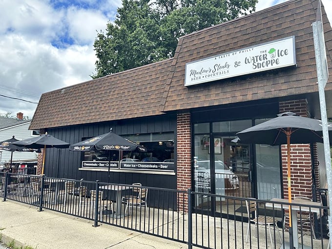Marlow's unassuming exterior might not stop traffic, but that brown-shingled roof shelters cheesesteak paradise. Those patio umbrellas hint at the treasures waiting inside.