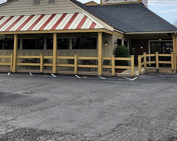 The red and white awning beckons like a lighthouse for hungry travelers. This unassuming exterior houses seafood treasures that rival coastal establishments.