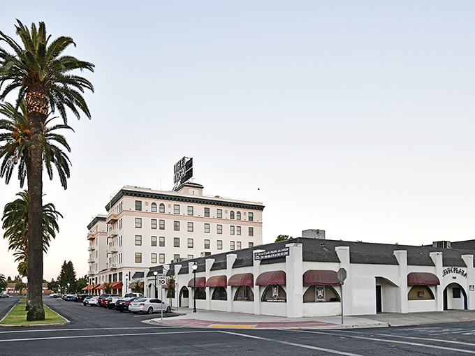 The historic El Capitan Hotel stands tall against California's endless blue sky, a testament to Merced's blend of affordability and architectural charm.