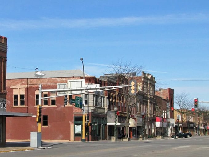 Albert Lea's historic downtown stretches beneath a perfect Minnesota blue sky, where brick buildings stand like sentinels of small-town affordability.
