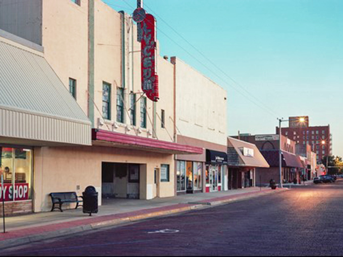 The historic Lyceum Theater stands as a sentinel of Clovis's past, its vintage neon sign glowing against the evening sky like a beacon from another era.